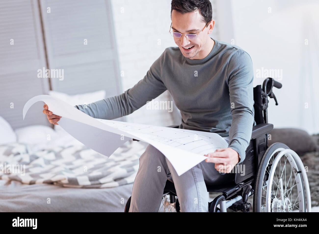 Attentive male person examining draw Stock Photo - Alamy