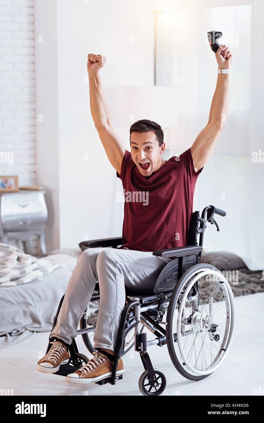 Full length photo of handsome man that raising both arms Stock Photo ...