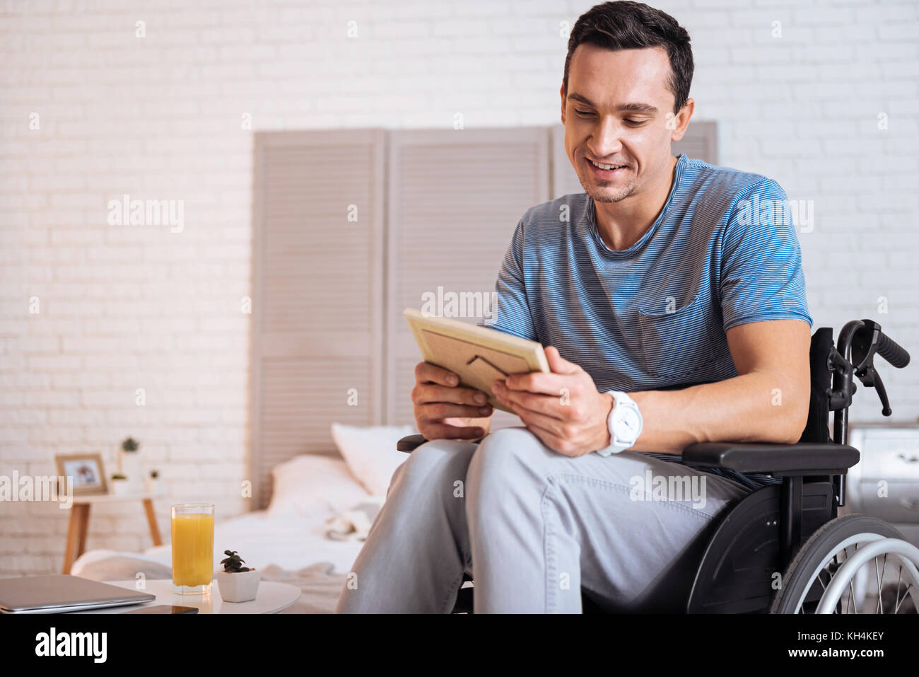 Kind male person keeping smile on his face Stock Photo - Alamy