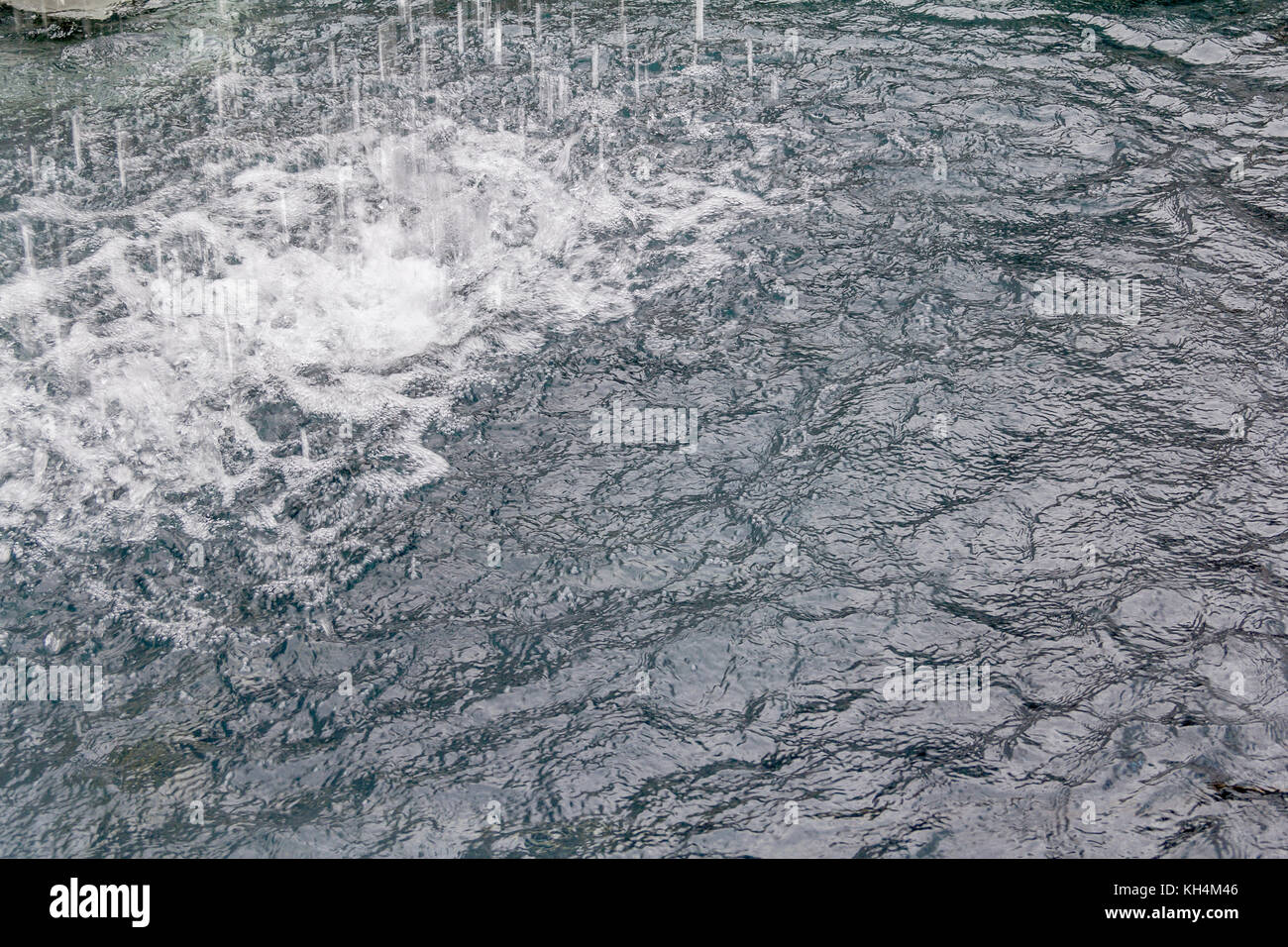 full frame background of a water surface with small waves, water drops ...