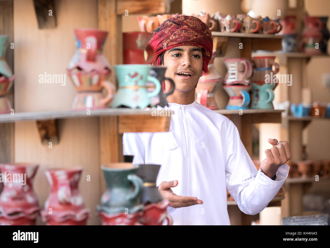 Young Omani boy performing a song in a traditional outfit. Nizwa, Oman ...