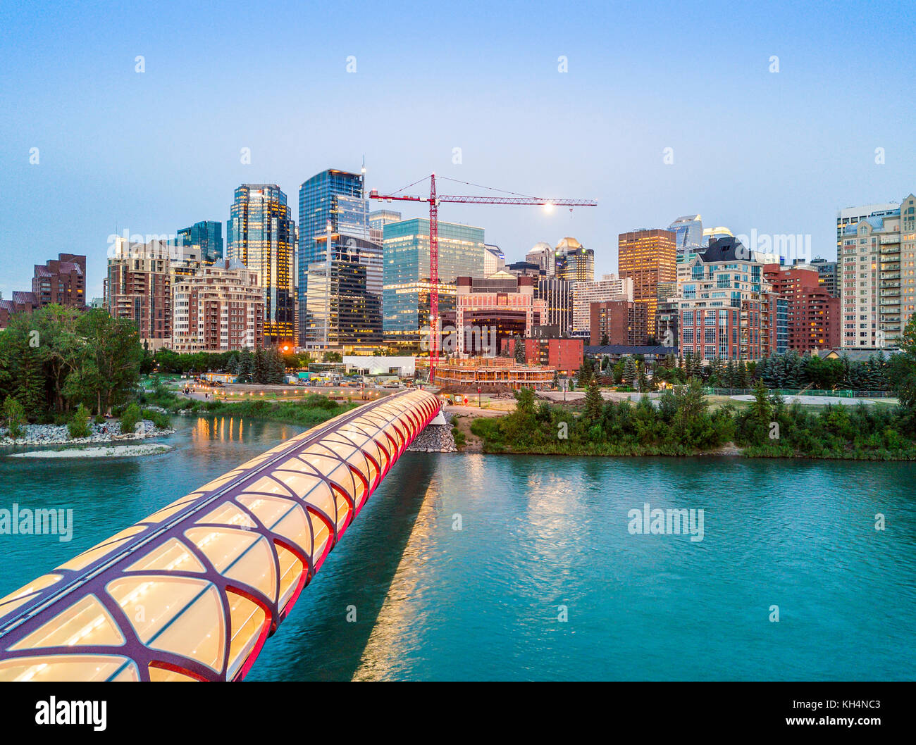 Calgary downtown with iluminated Peace Bridge and full moon, Alberta ...