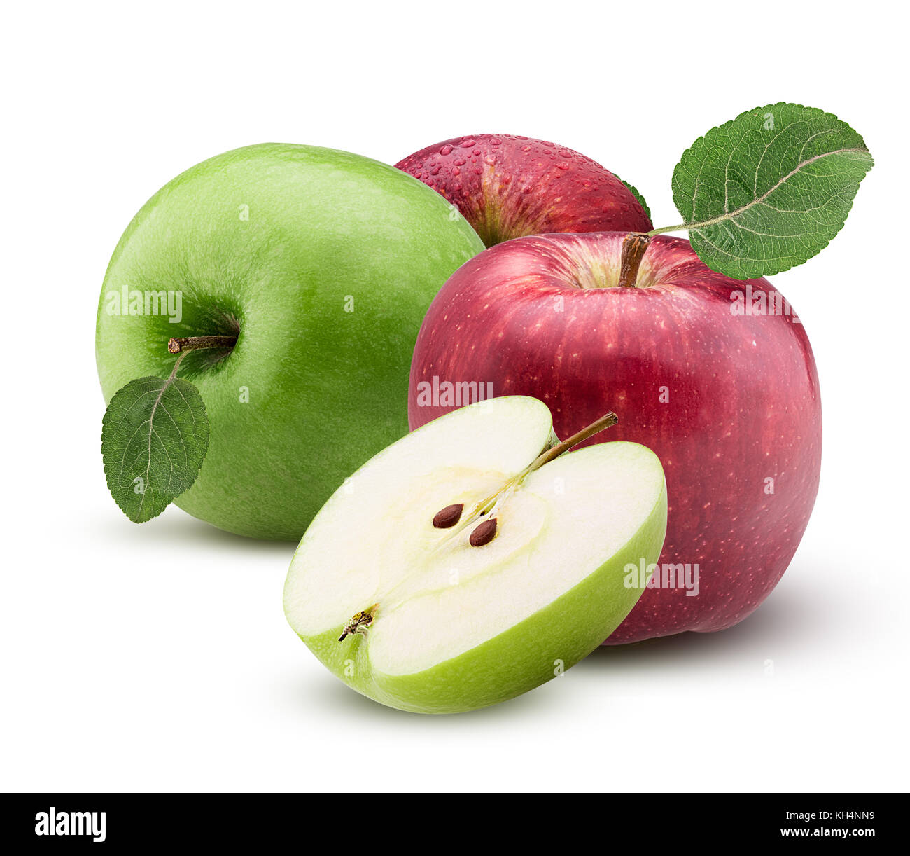 Red and green apples one cut in half with leaf with water drops ...