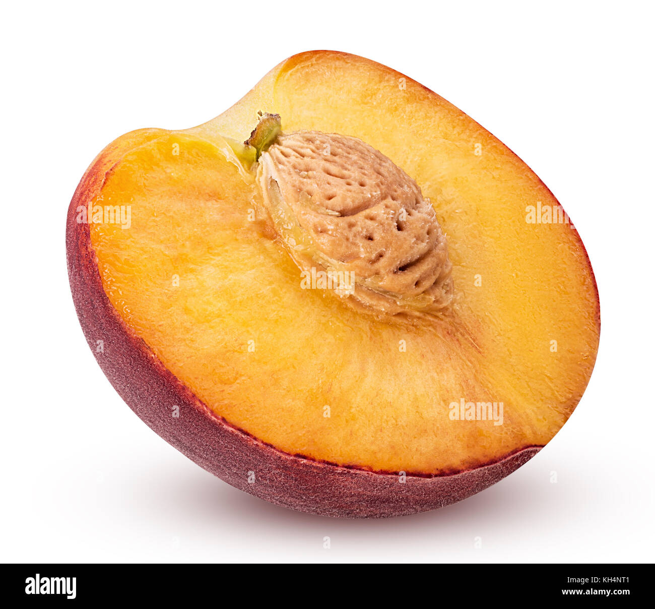 Ripe peach fruit cut in half with bone isolated on white background ...
