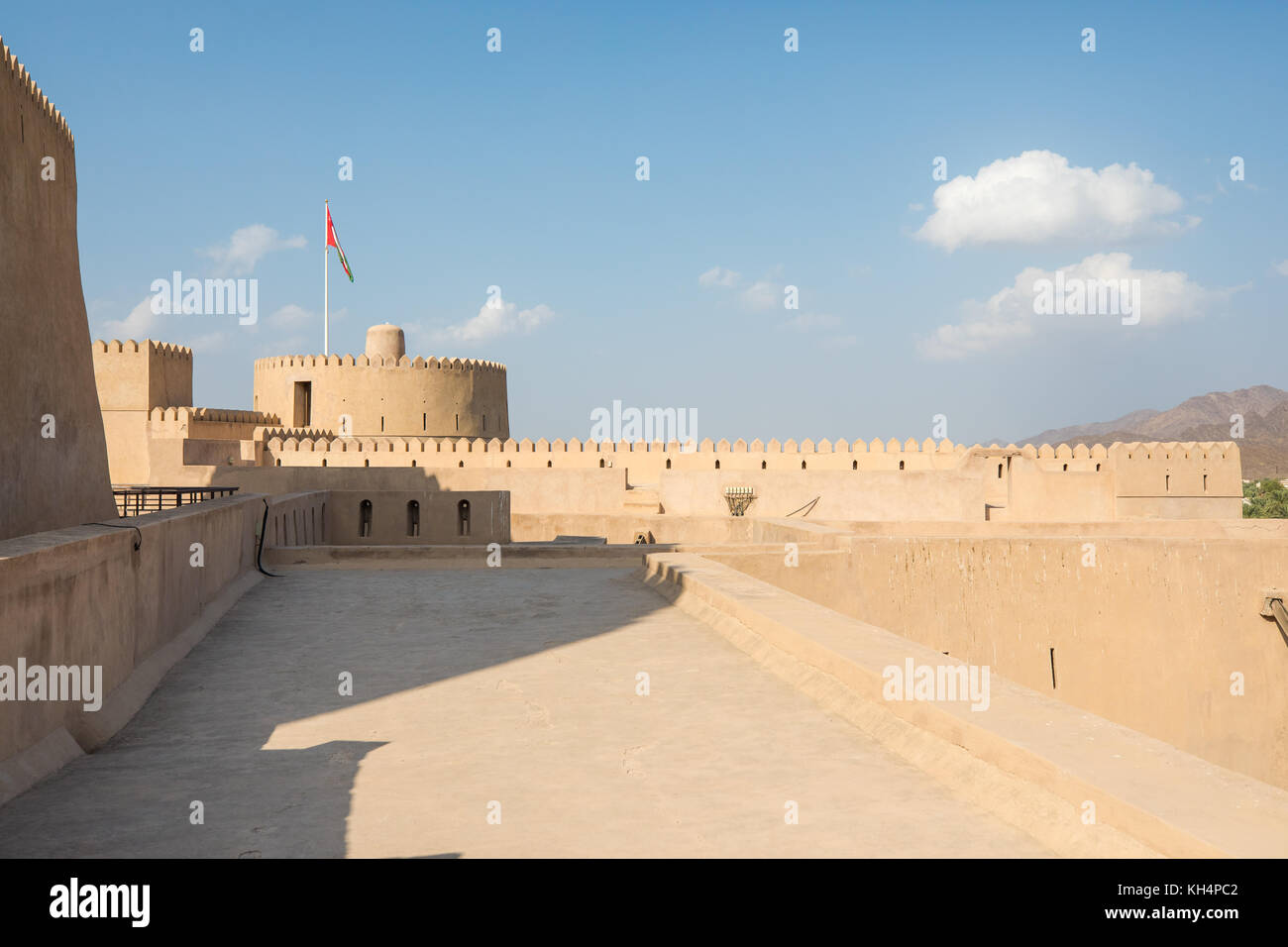 Rustaq castle with an Omani flag on a sunny day. Rustaq, Oman Stock ...