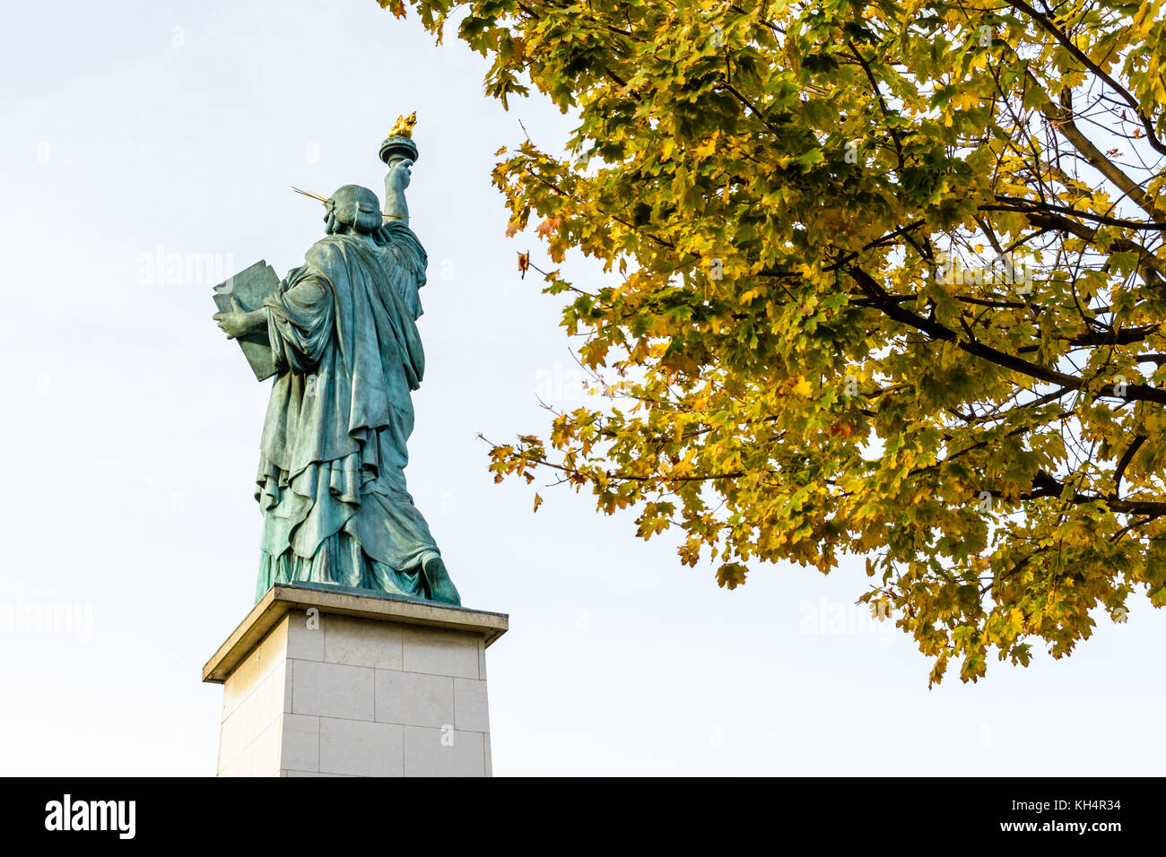 Rear view from below of the Statue of Liberty in Paris with yellow ...