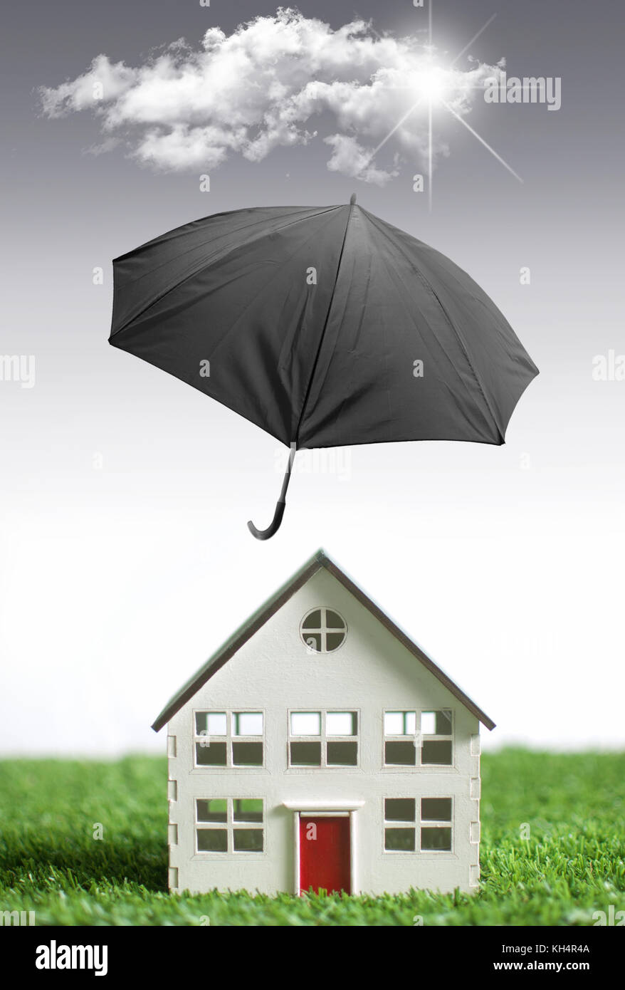 Umbrella protecting a house from bad weather Stock Photo - Alamy