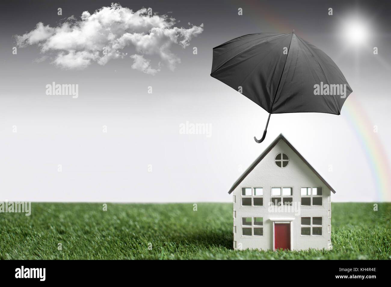 Umbrella protecting a house from bad weather with background space ...