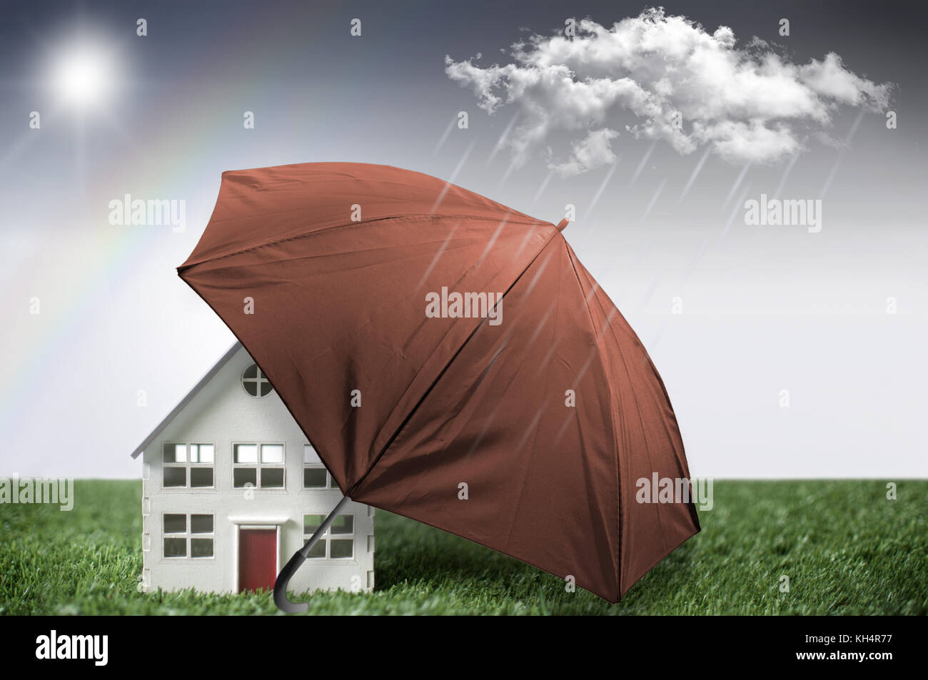 Umbrella protecting a house from bad weather Stock Photo - Alamy