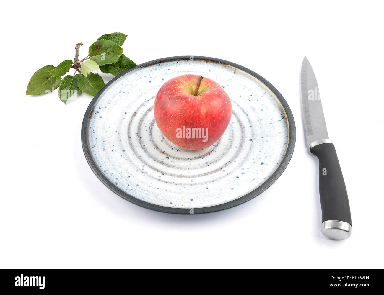 Apple on plate and white Stock Photo - Alamy