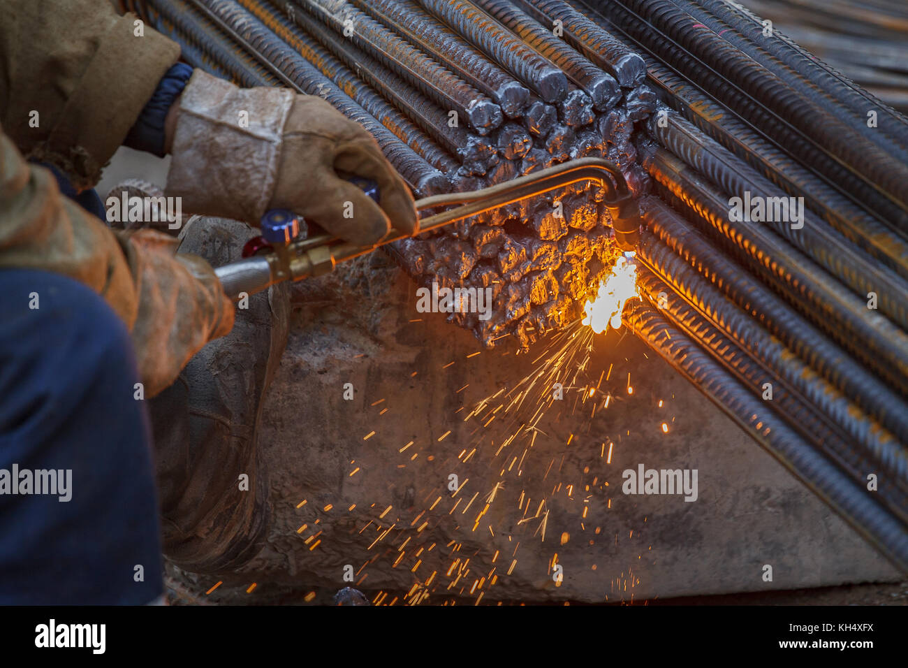 Gas cutting of metal fittings. Working gloves. Sparks Stock Photo - Alamy