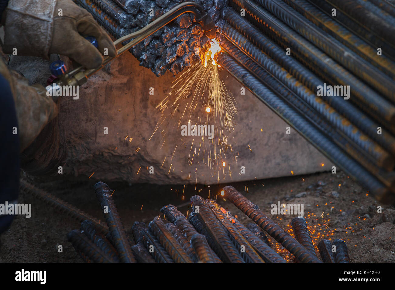 Gas cutting of metal fittings. Working gloves. Sparks Stock Photo - Alamy