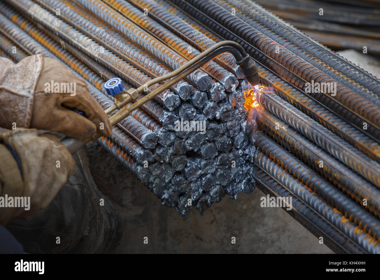 Gas cutting of metal fittings. Working gloves. Sparks Stock Photo - Alamy