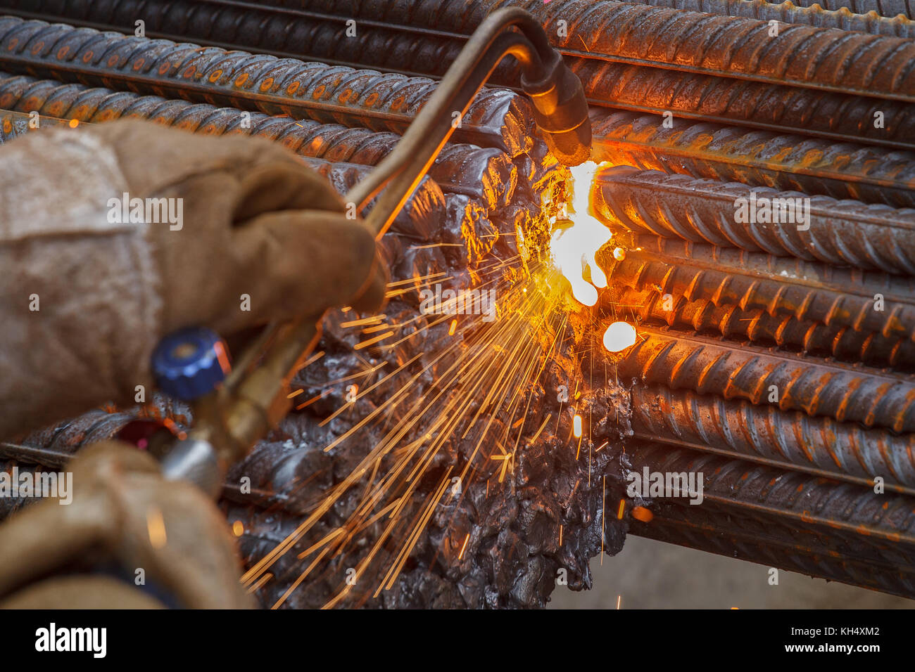 Gas cutting of metal fittings. Working gloves. Sparks Stock Photo - Alamy