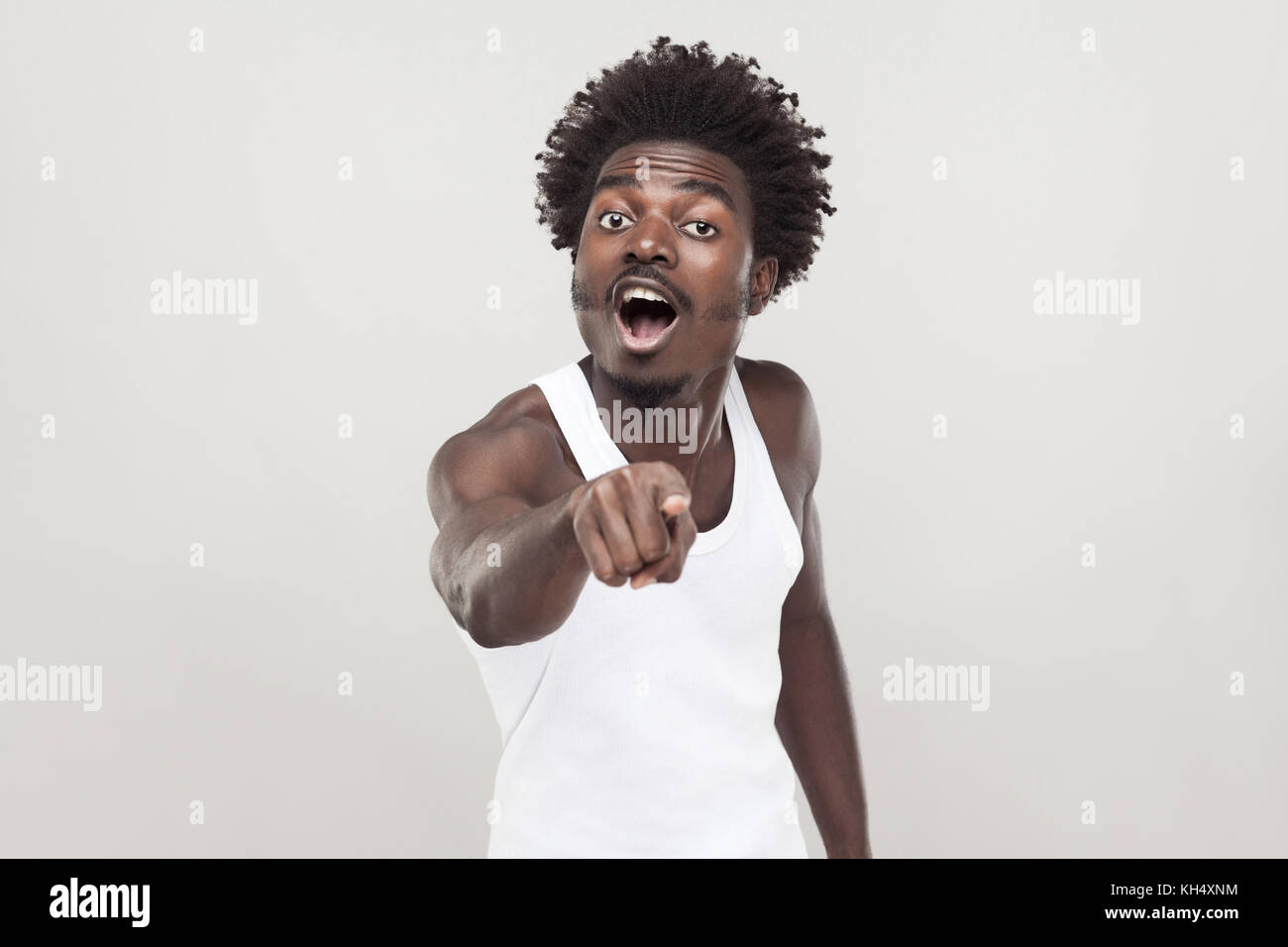 Young man point at biceps hi-res stock photography and images - Alamy