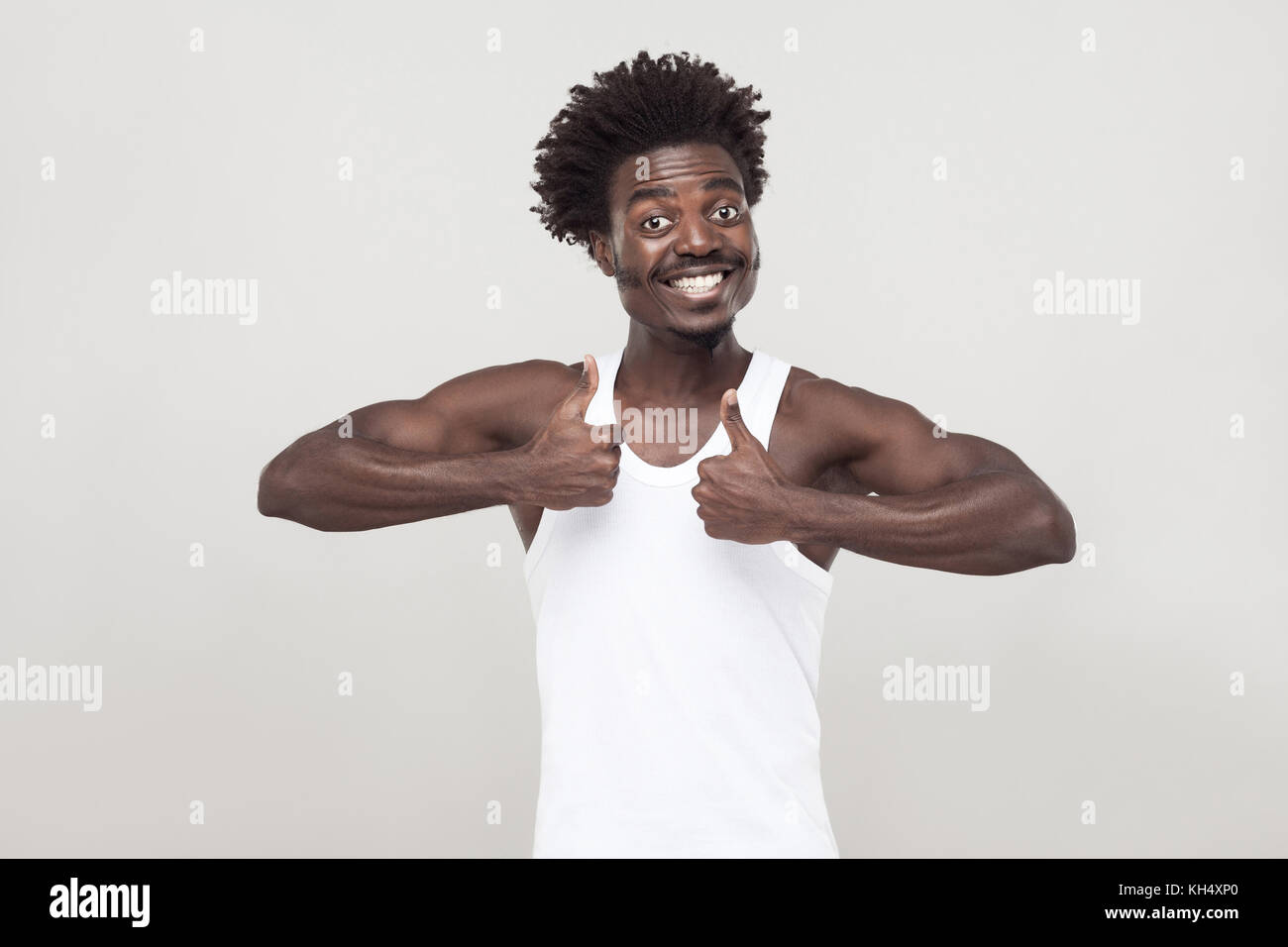 Funny afro man with mustache, looking at camera, smiling, thumbs up ...