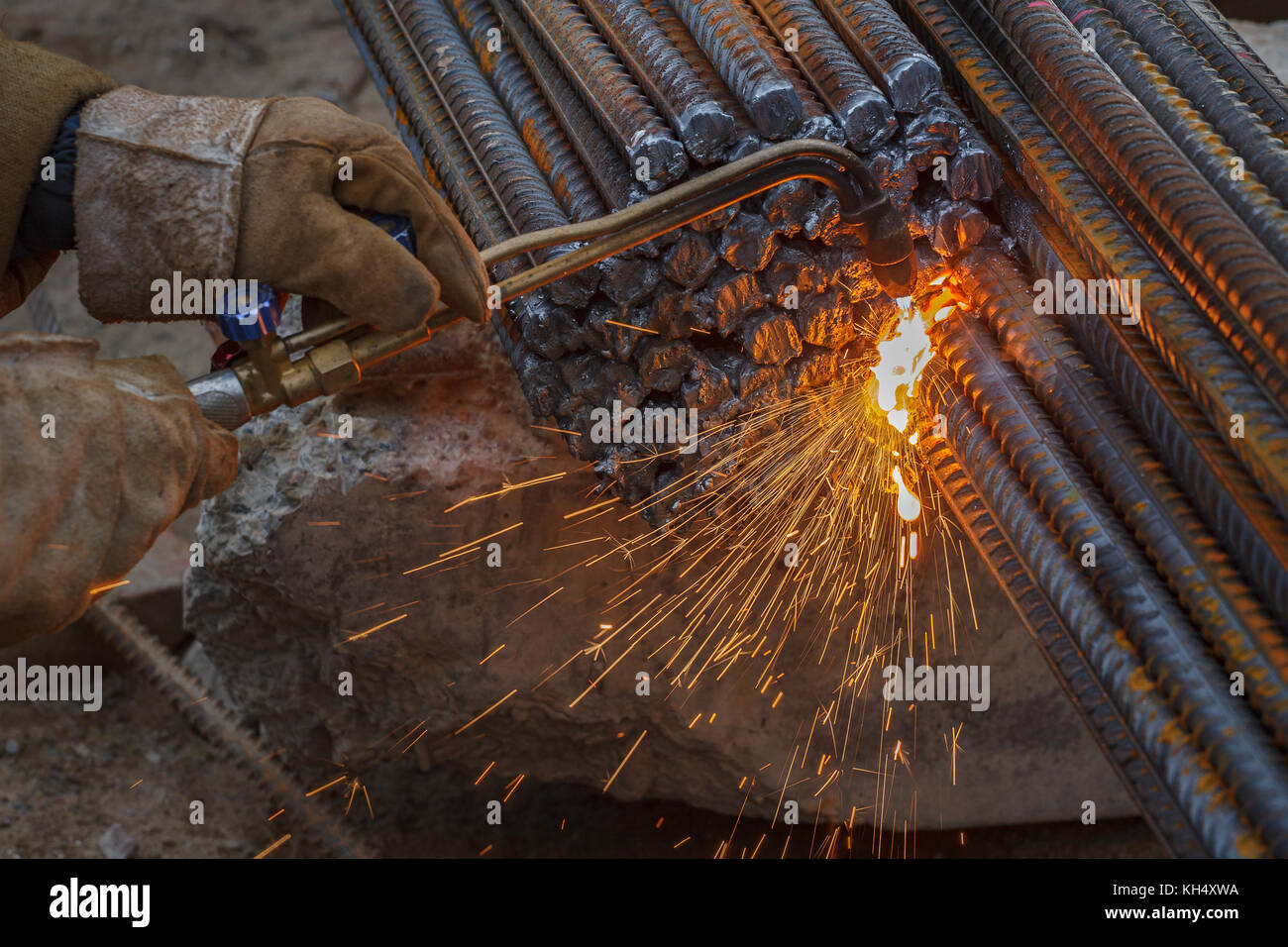 Gas cutting of metal fittings. Working gloves. Sparks Stock Photo - Alamy