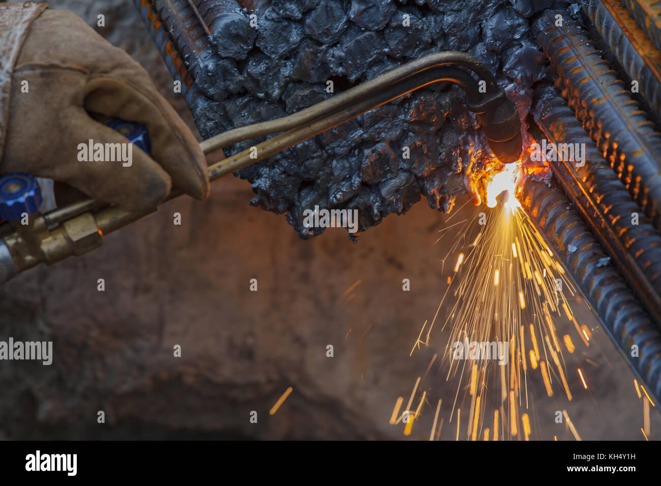 Gas cutting of metal fittings. Working gloves. Sparks Stock Photo - Alamy
