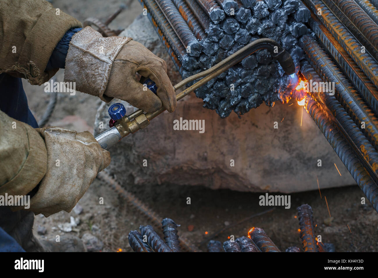 Gas cutting of metal fittings. Working gloves. Sparks Stock Photo - Alamy