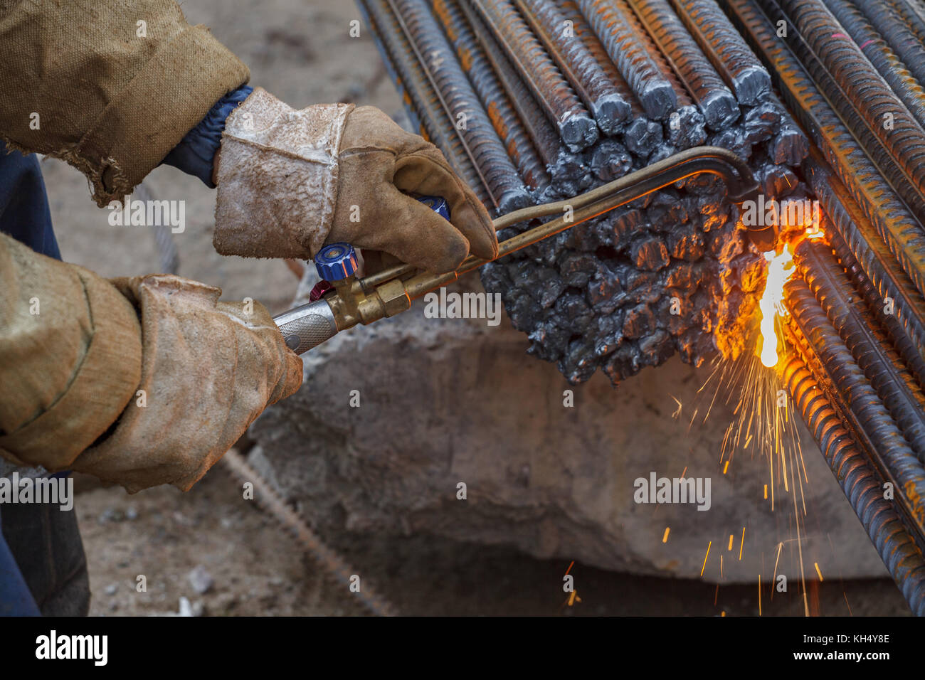 Gas cutting of metal fittings. Working gloves. Sparks Stock Photo - Alamy