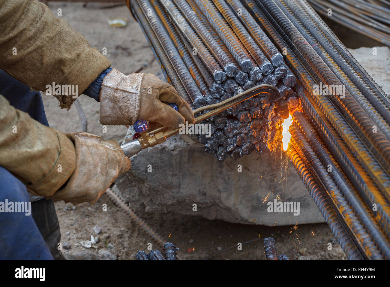 Gas cutting of metal fittings. Working gloves. Sparks Stock Photo - Alamy