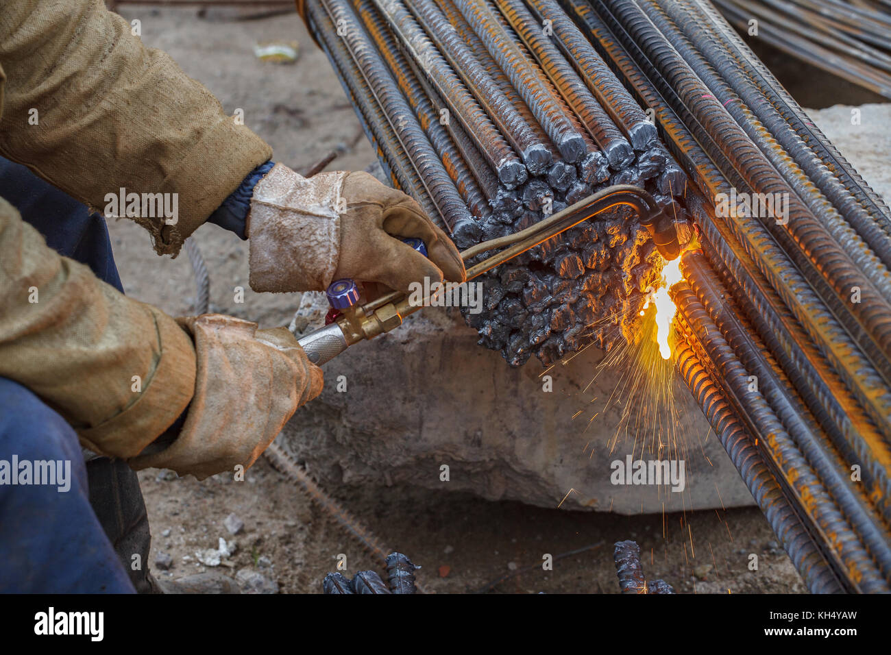 Gas cutting of metal fittings. Working gloves. Sparks Stock Photo - Alamy