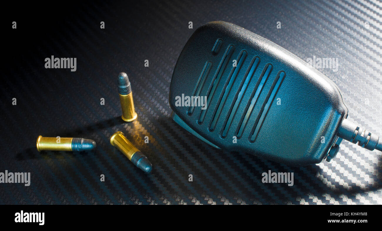 Three slim rim fire bullets with a police microphone Stock Photo - Alamy