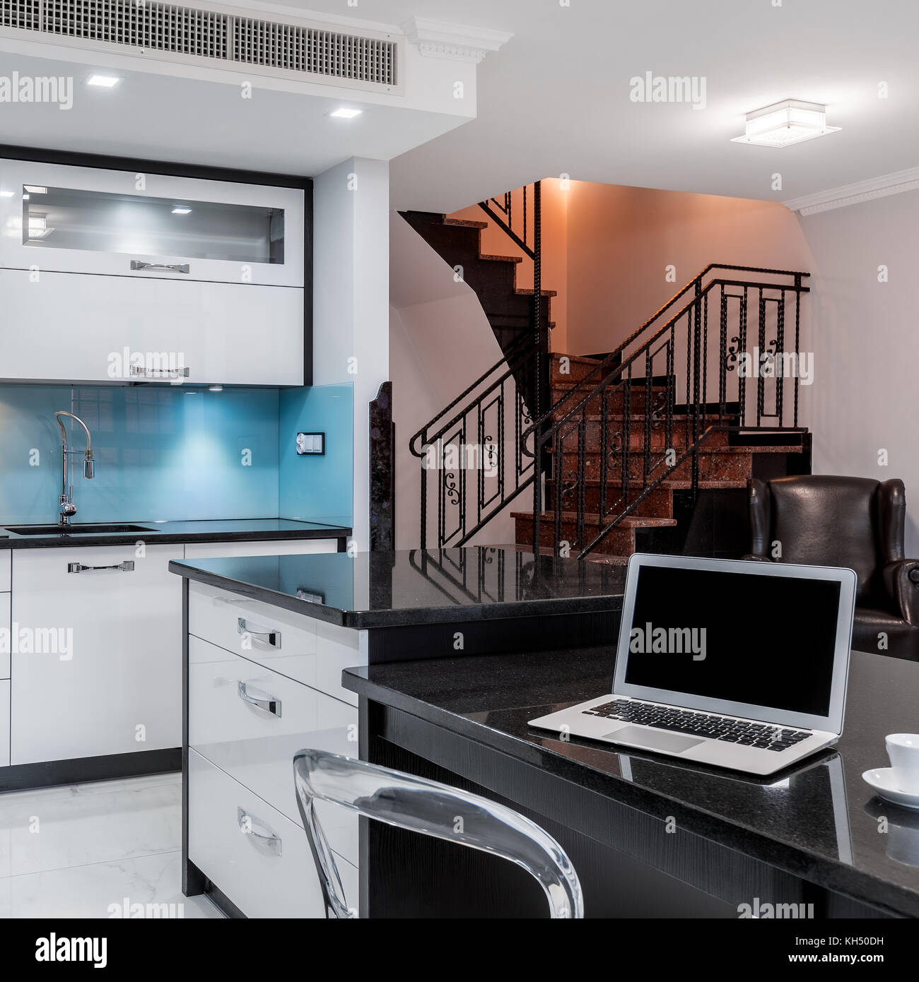 Fancy open kitchen space with laptop on the countertop Stock Photo - Alamy