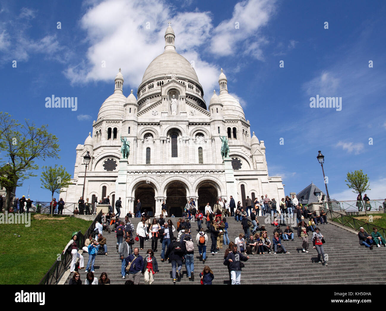 Tourists on steps at Basilica of the Sacred Heart of Paris, commonly ...