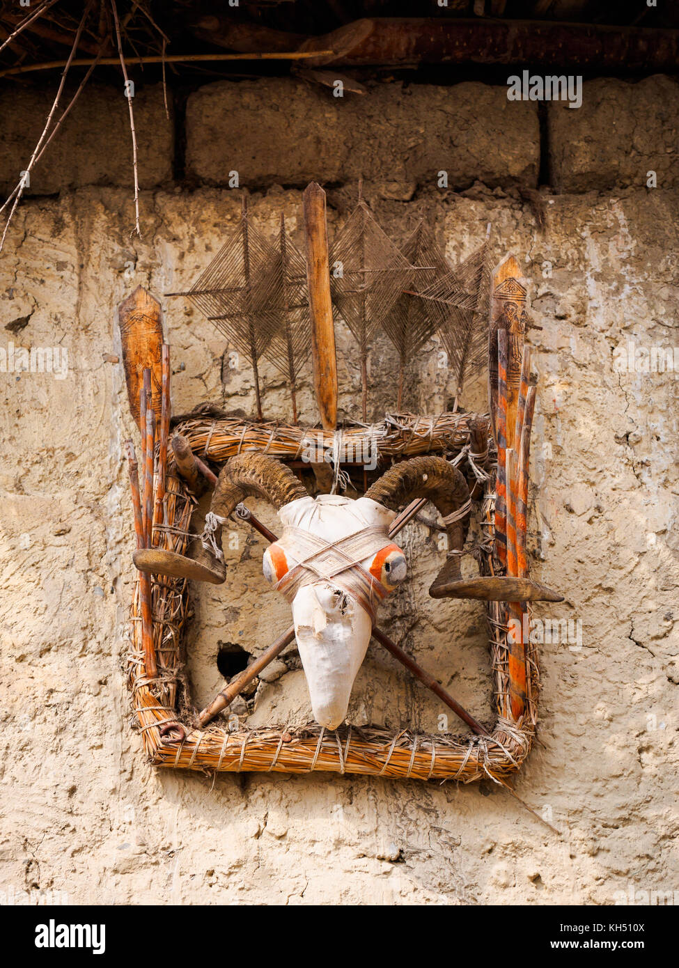 Traditional animist spirit catcher on the exterior wall of a house in ...
