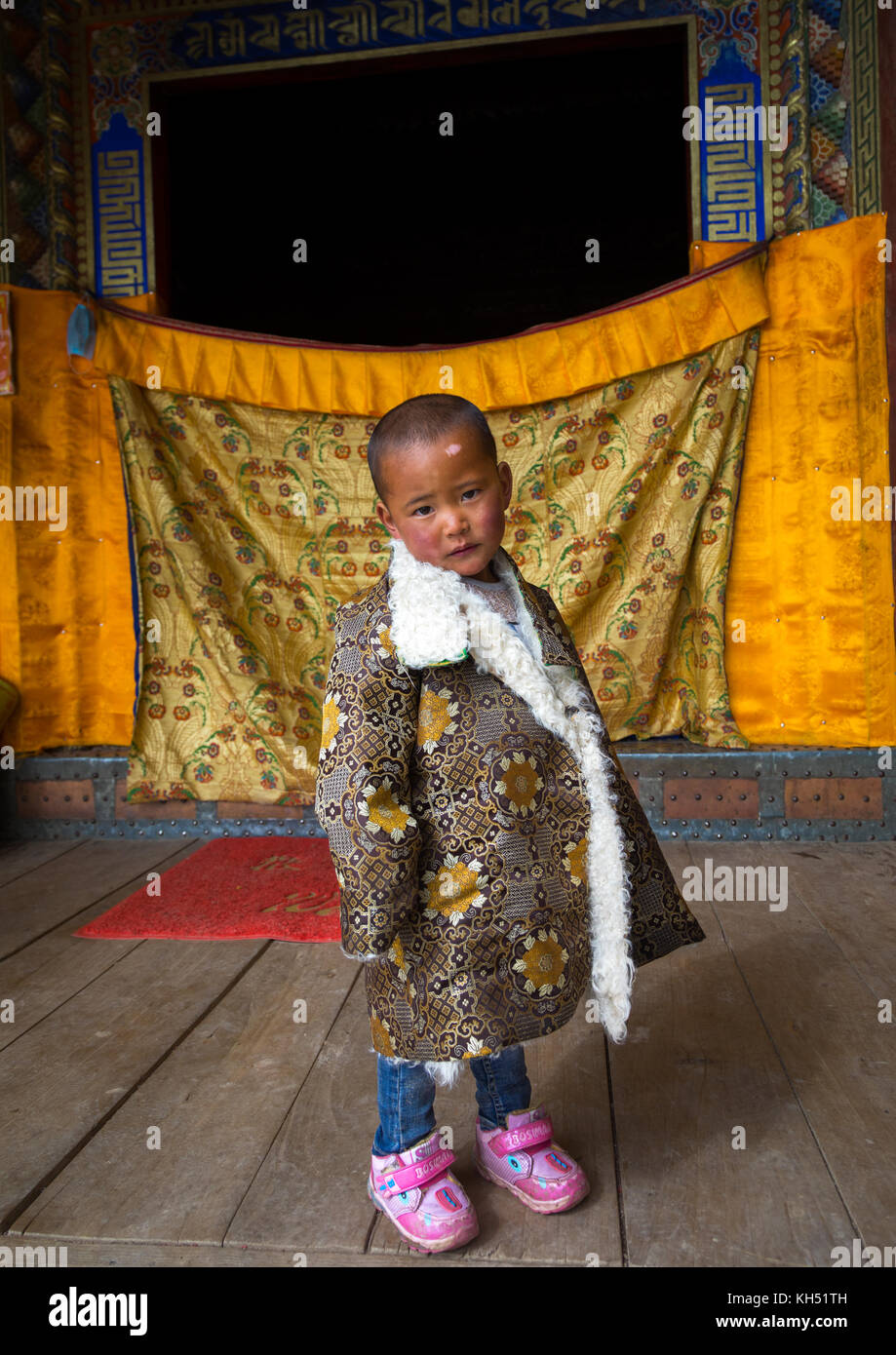 Tibetan child boy in traditional clothing in Shachong monastery ...