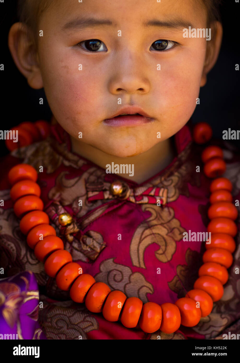 Tibetan child girl with a huge necklace, Tongren County, Rebkong, China ...