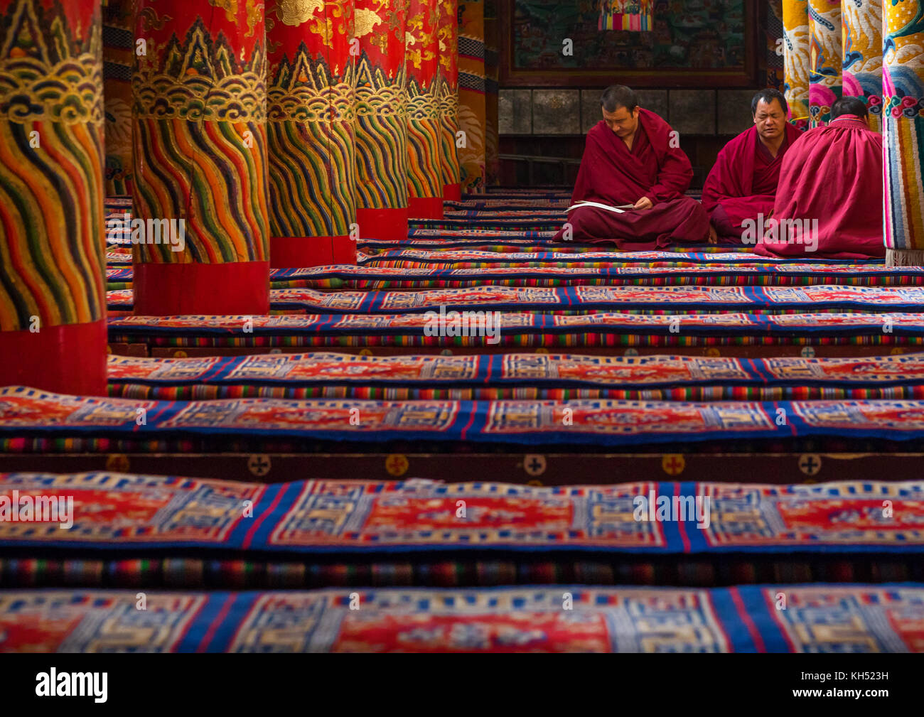 Monks praying and meditating inside Longwu monastery, Tongren County ...
