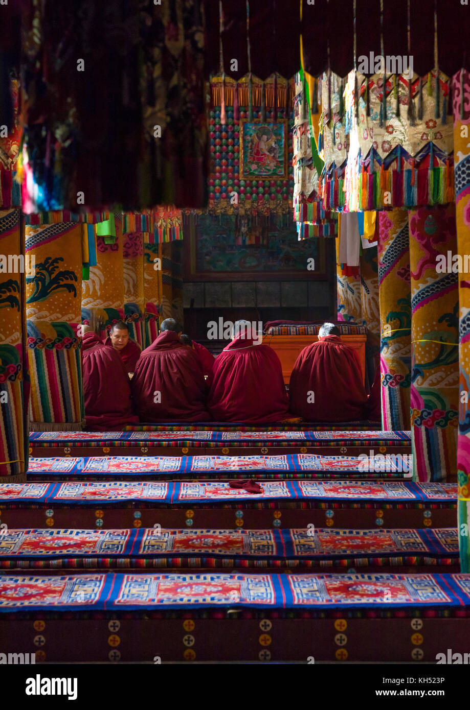 Monks praying and meditating inside Longwu monastery, Tongren County ...
