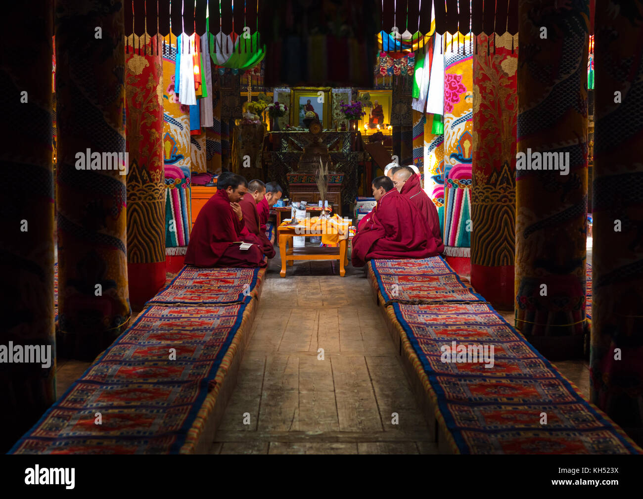 Monks praying and meditating inside Longwu monastery, Tongren County ...