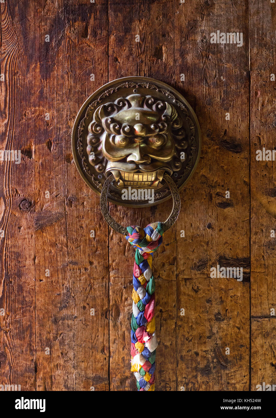 Ornate knockers on traditional buddhist door temple in Rongwo monastery ...