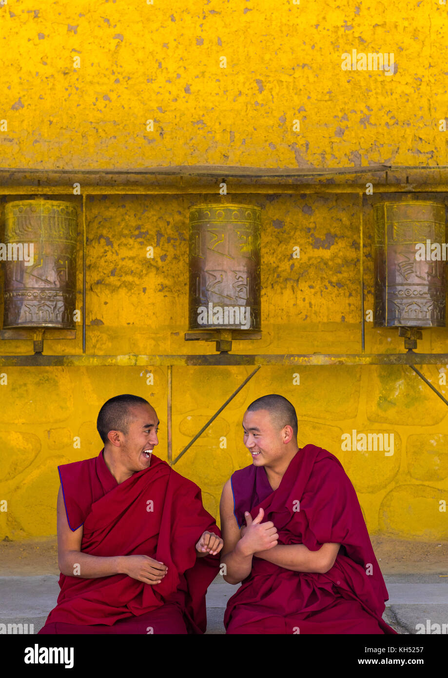 Monks debating in front of prayer wheels in a Rongwo monastery, Tongren ...
