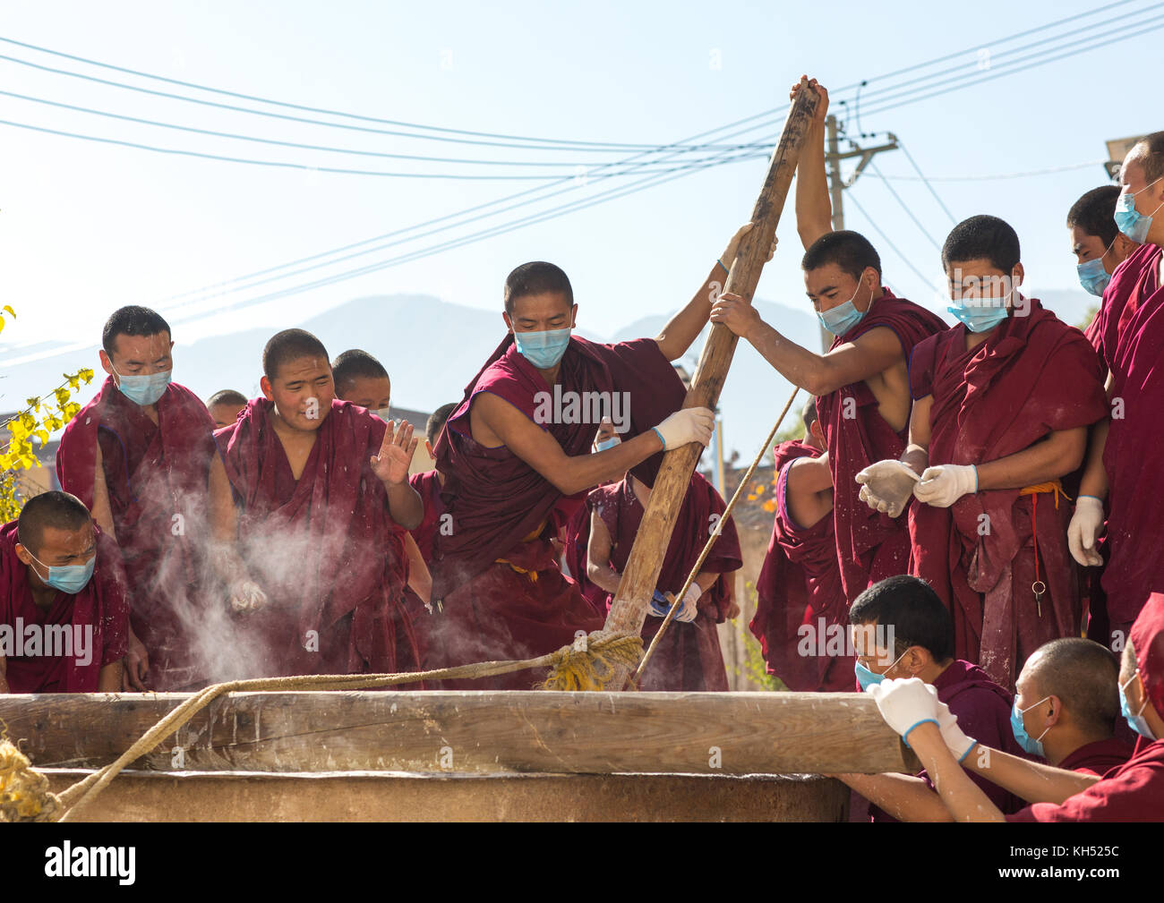 Monks preparaing the painting of a temple in Rongwo monastery, Tongren ...
