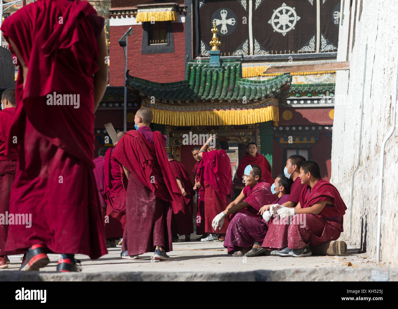 Monks painting the walls of a temple in Rongwo monastery, Tongren ...