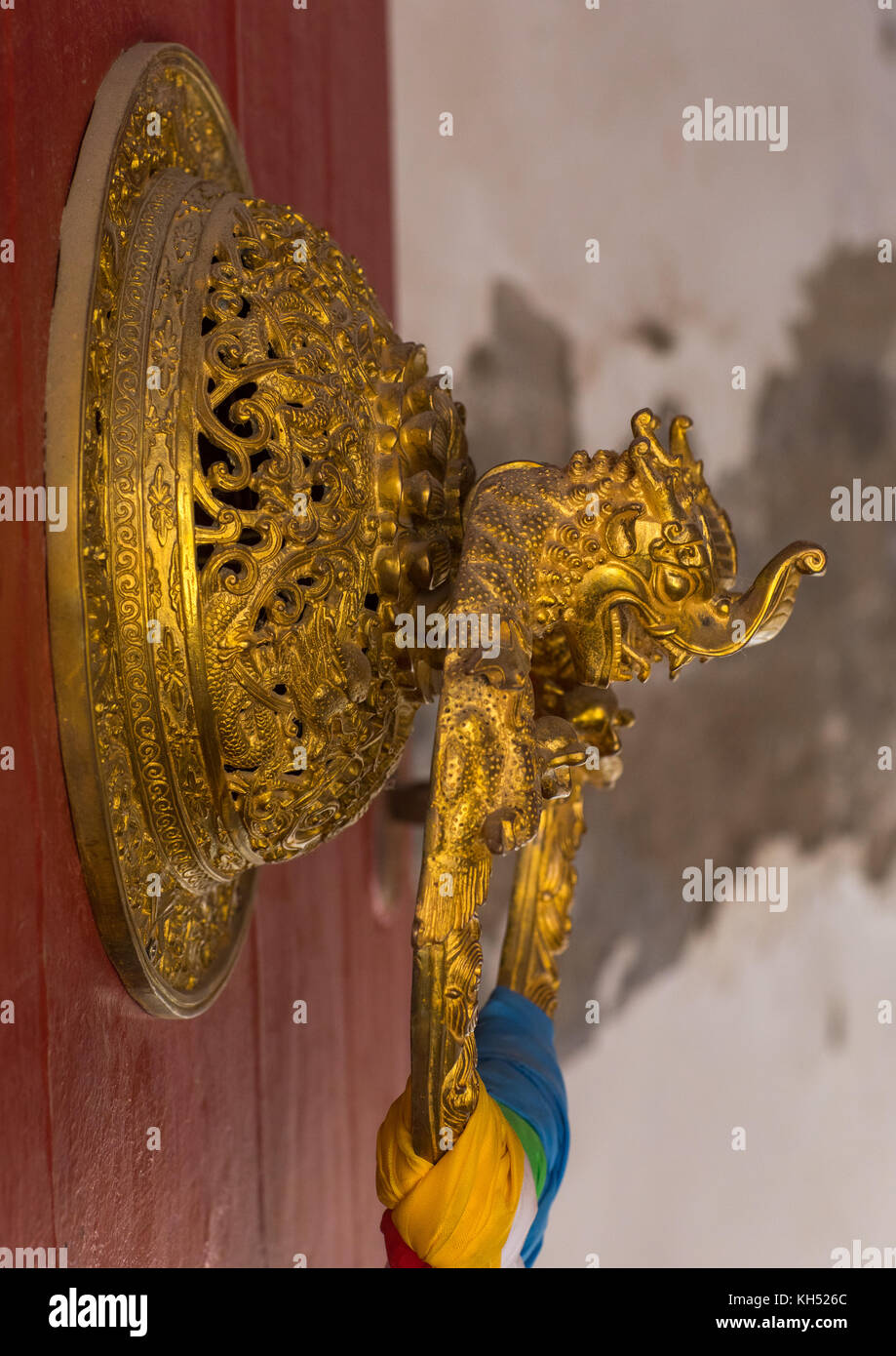 Ornate knocker on traditional buddhist door temple in Rongwo monastery ...