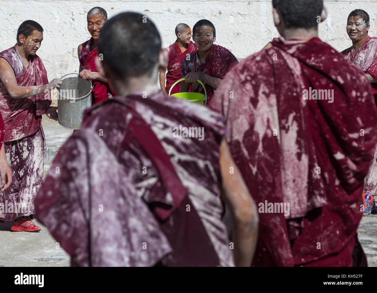 Tibetan monks enjoying a water fight after the yearly renovation of the ...