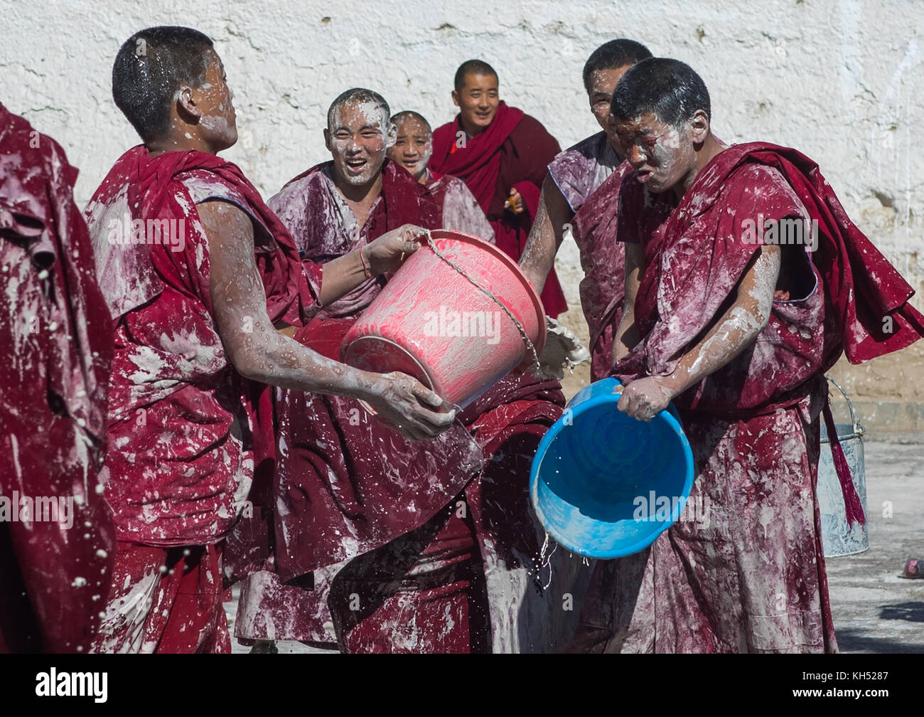 Tibetan monks enjoying a water fight after the yearly renovation of the ...