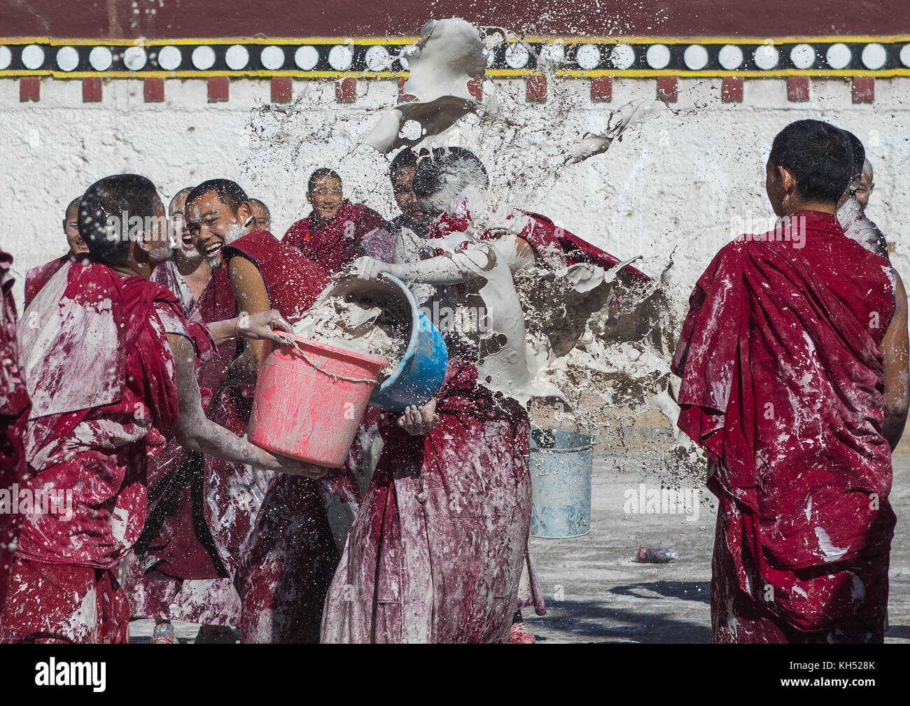 Tibetan monks enjoying a water fight after the yearly renovation of the ...