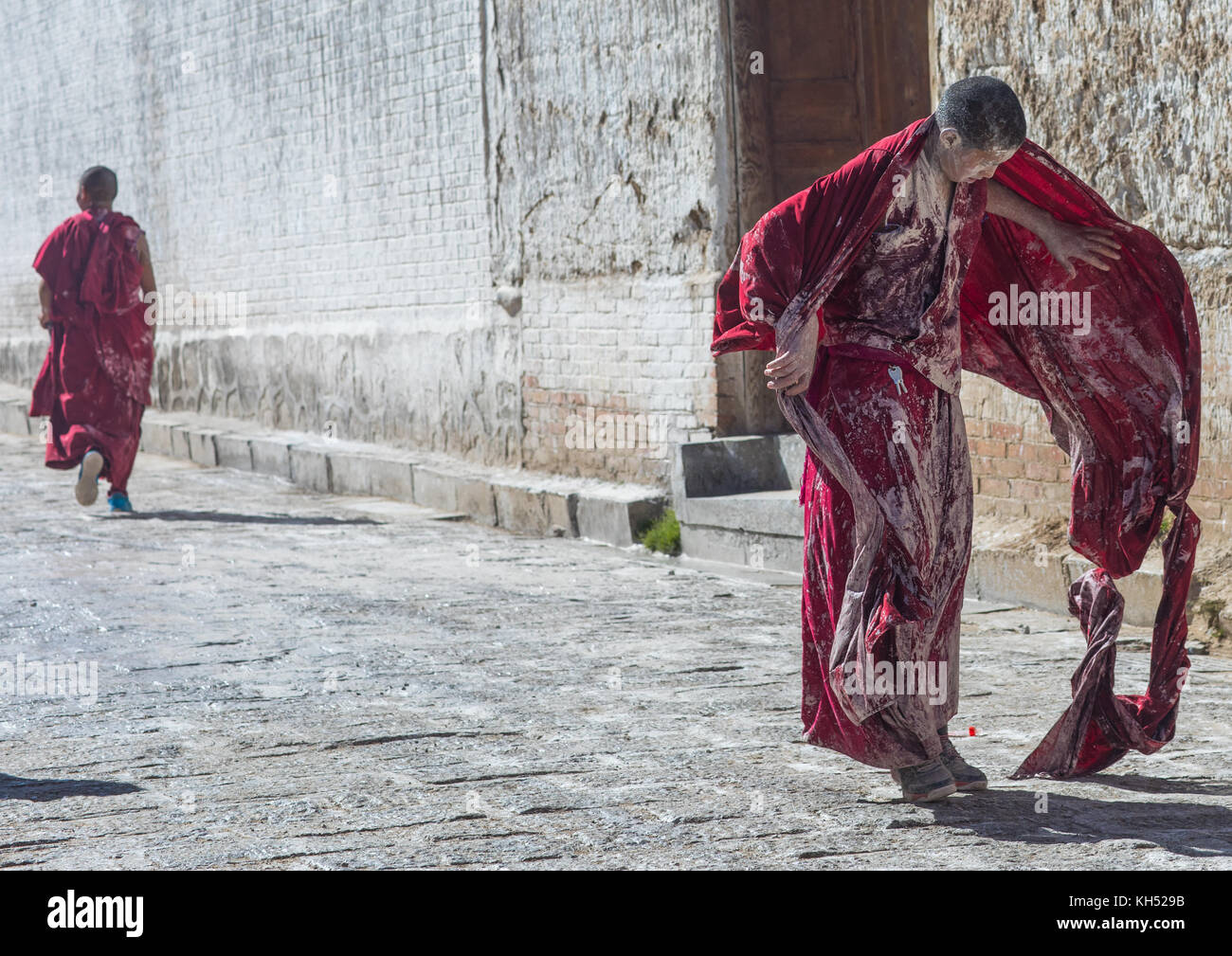 Tibetan monks enjoying a water fight after the yearly renovation of the ...
