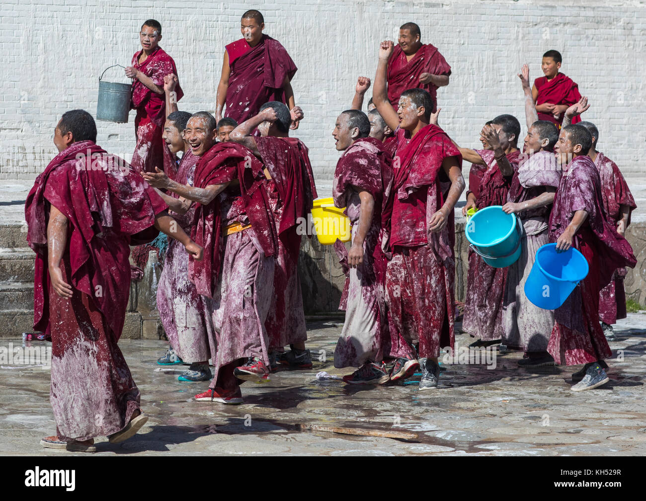 Tibetan monks enjoying a water fight after the yearly renovation of the ...
