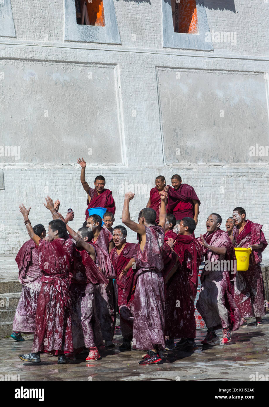 Tibetan monks enjoying a water fight after the yearly renovation of the ...