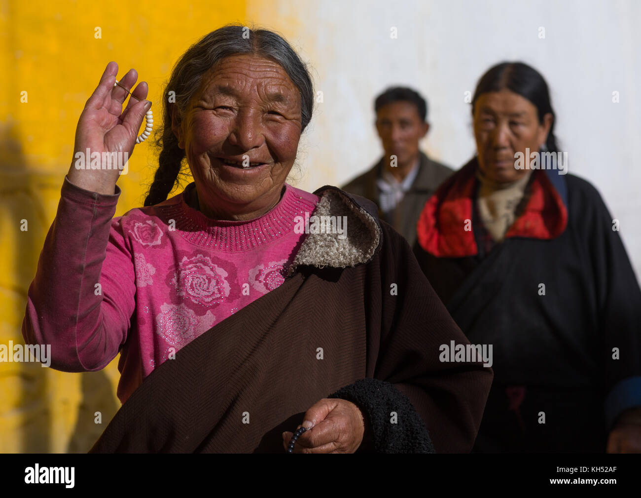 Pilgrim tibetan pilgrims walking the kora around Rongwo monastery ...