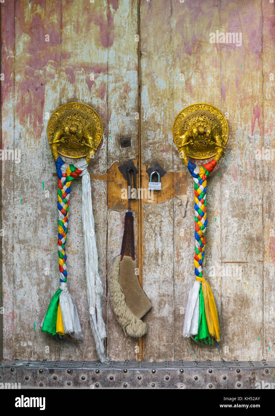 Ornate knockers on traditional buddhist door temple in Rongwo monastery ...
