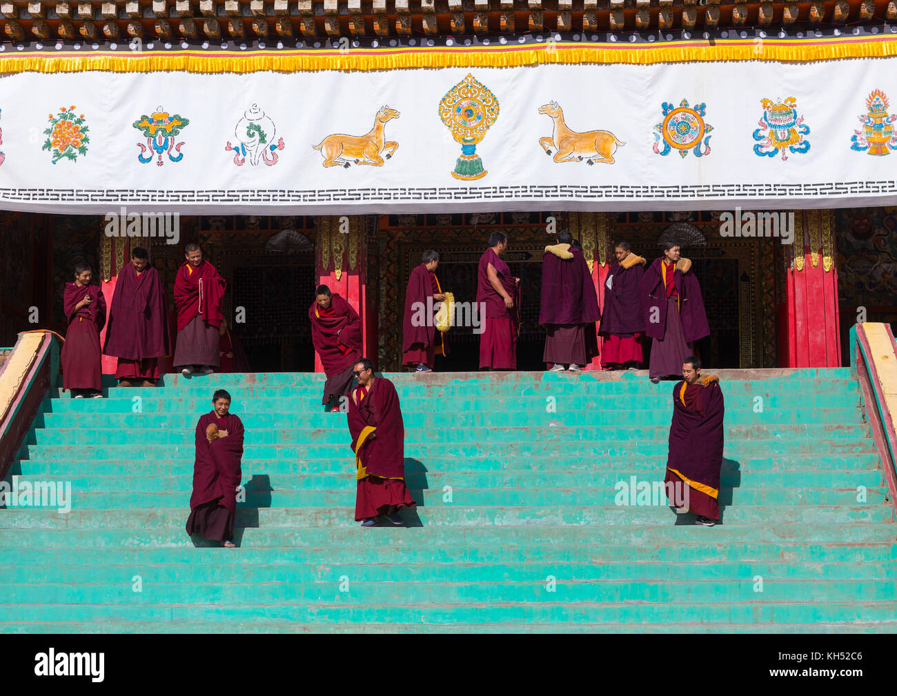 Tibetan monks of the gelug order or yellow hat sect on the stairs in ...