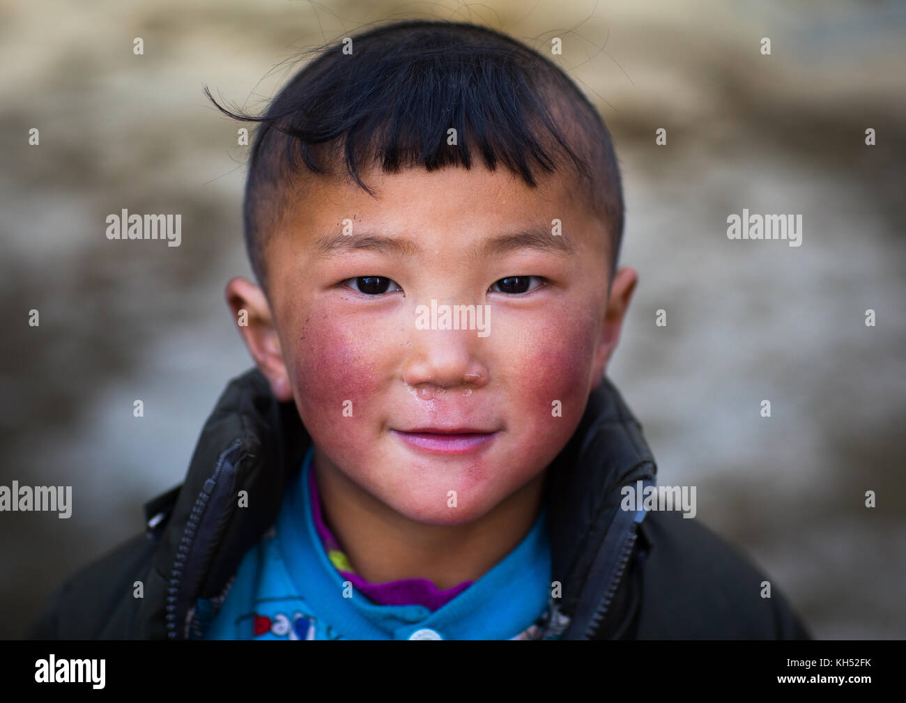 Portrait of a tibetan nomad child with his cheeks reddened by the harsh ...